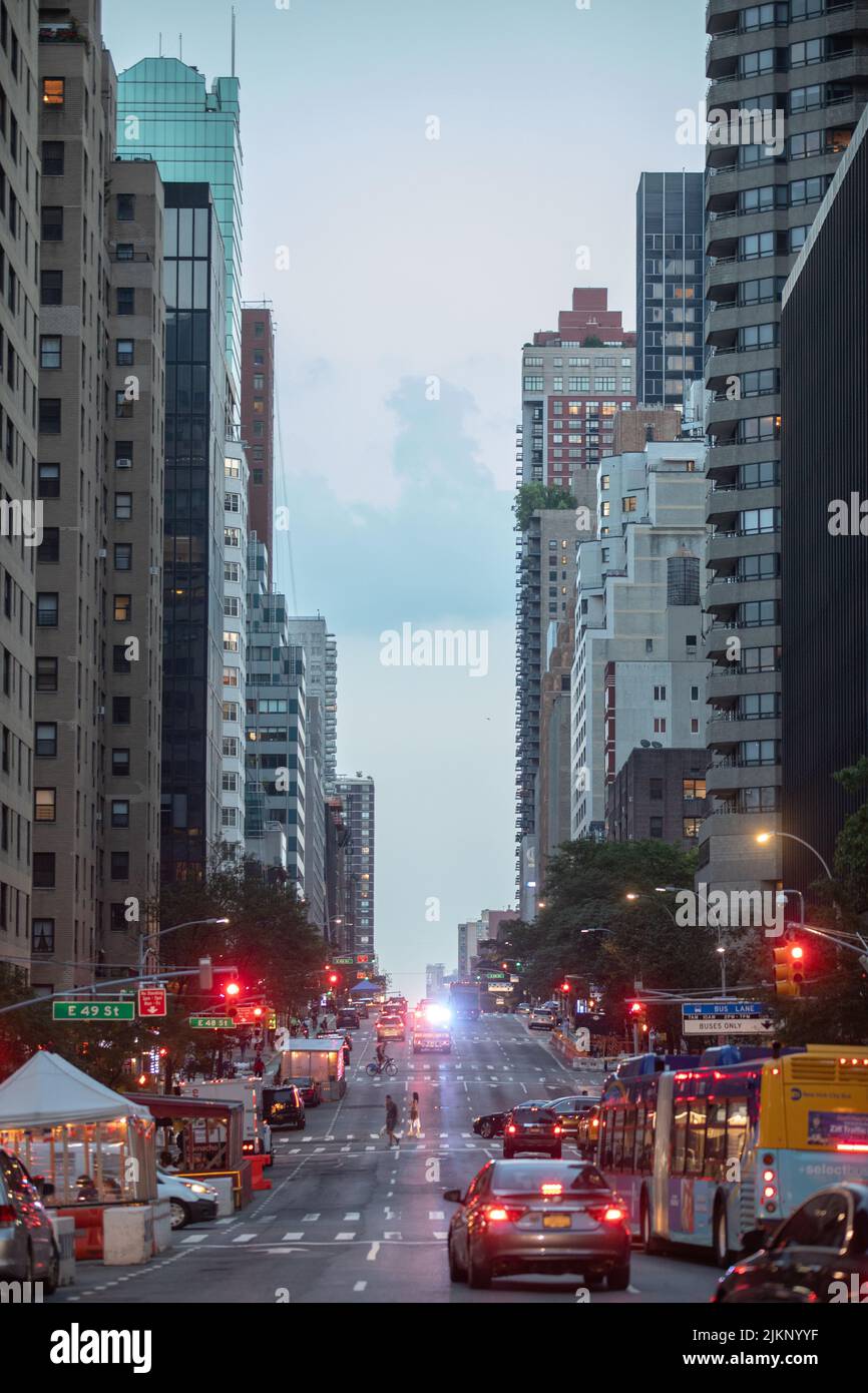 A street between tall buildings in the New York City Avenue Stock Photo ...