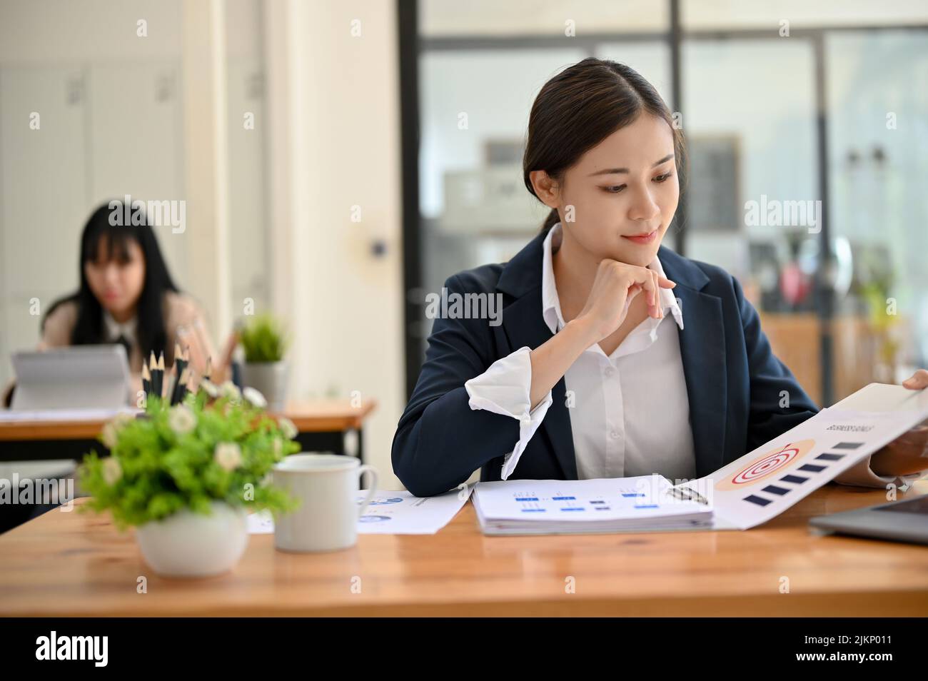 Attractive millennial Asian businesswoman or female financial worker ...