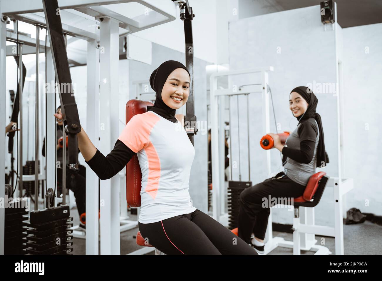 woman using chest press machine during fitness at the gym Stock Photo ...