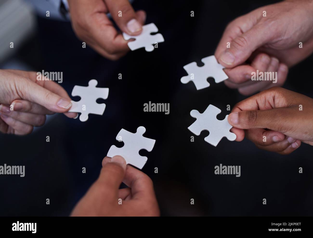 Working in a group takes less time. a group of businesspeople putting ...