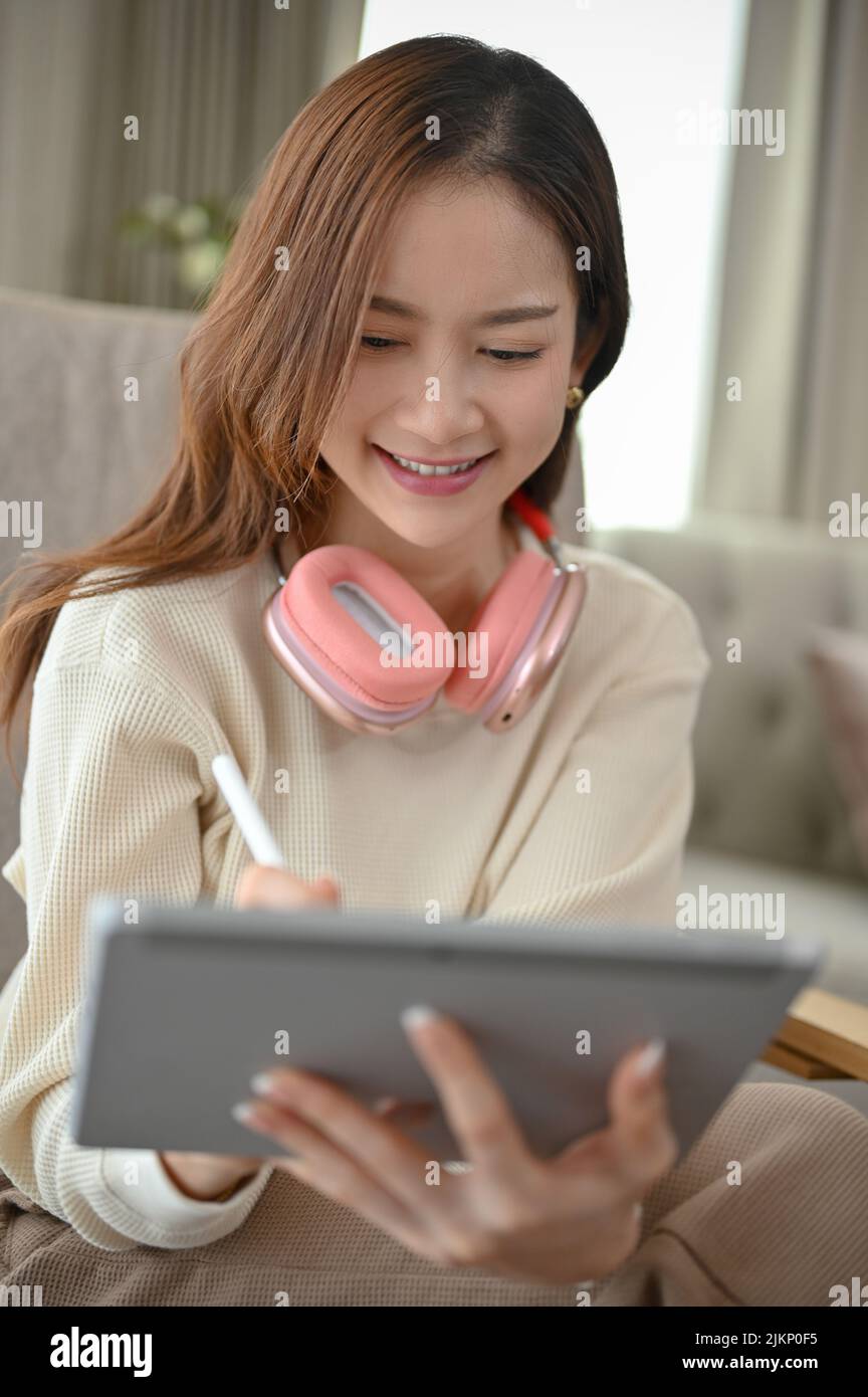 Portrait, Beautiful and attractive young Asian woman with wireless ...