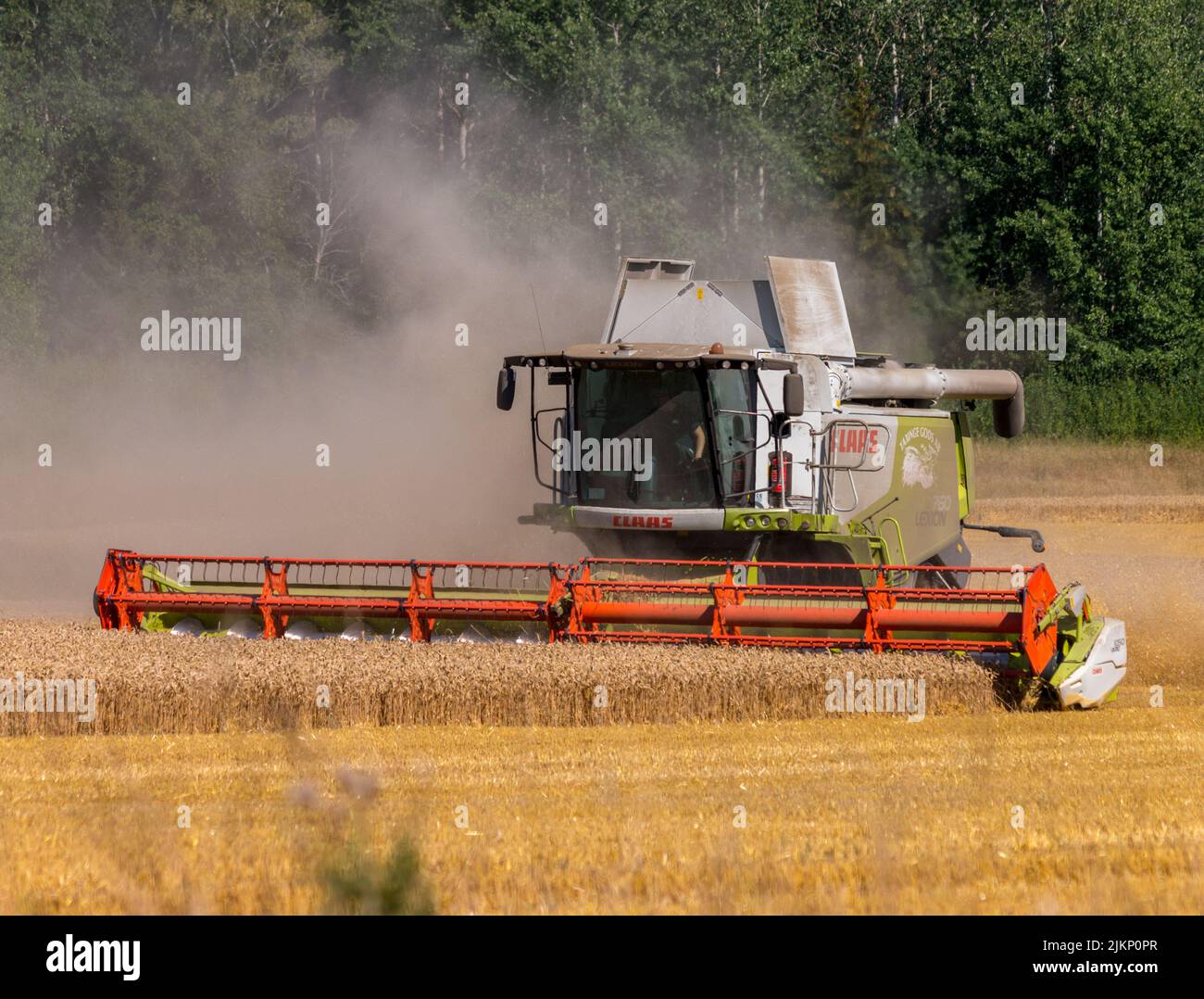A beautiful shot of a Harvest machine during dusty harvest in Sweden ...