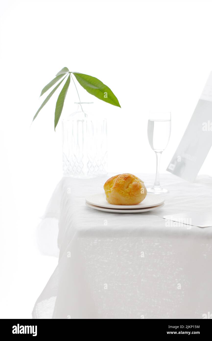 A scenic shot of homemade fresh bread on a plate on the table in a full ...