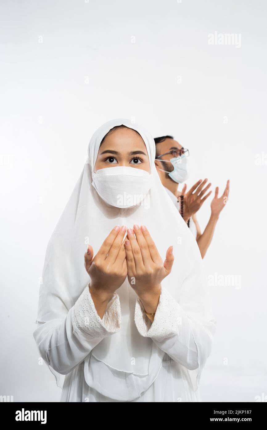 Woman wearing mask with two palms up in prayer Stock Photo - Alamy