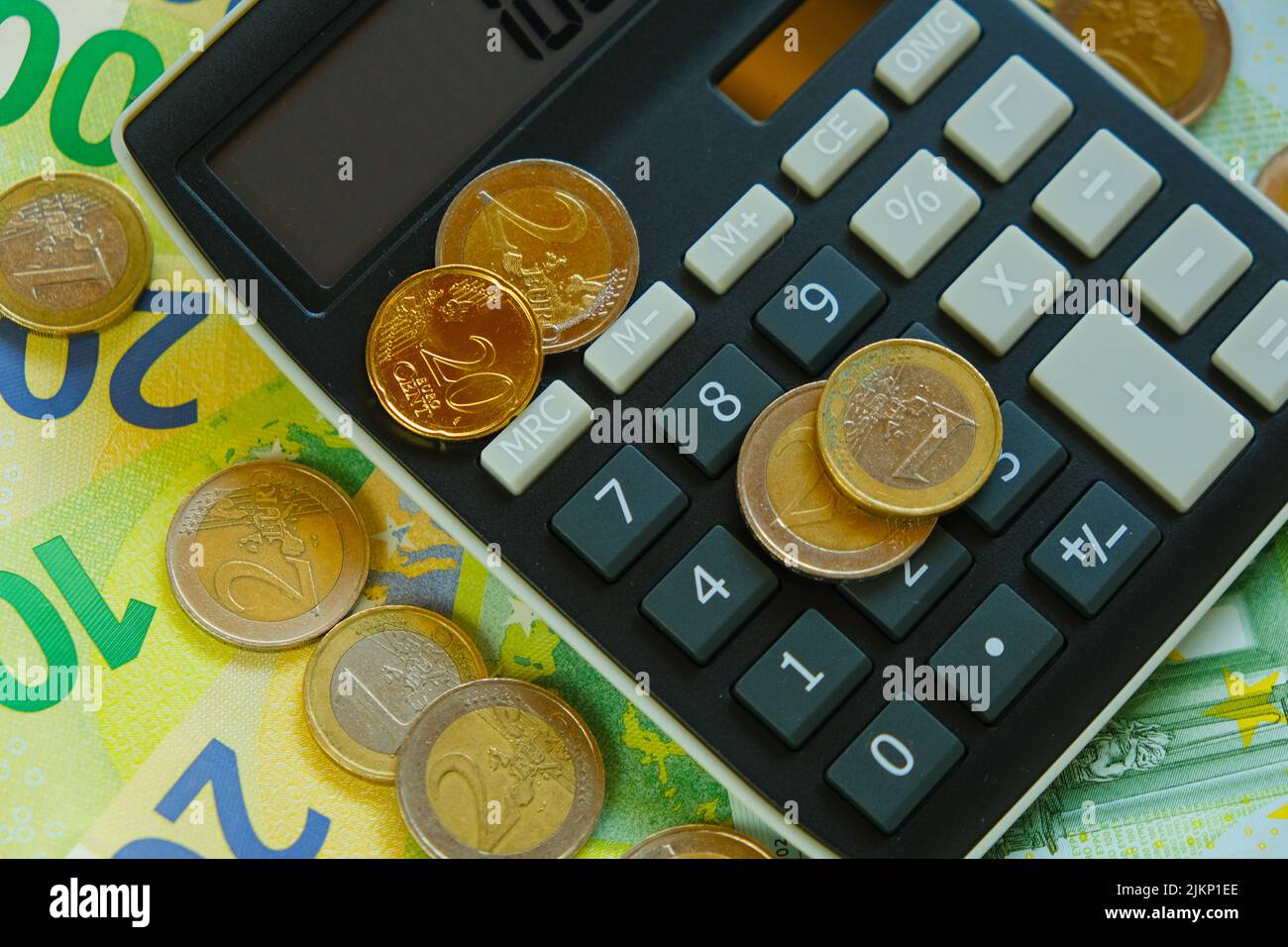 Recalculation of money. Calculator and euro coins on euro banknotes ...