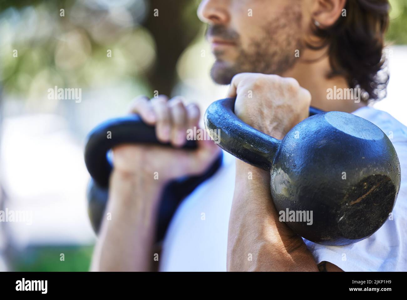 All about the gains. a unrecognizable man exercising with his dumbbells ...