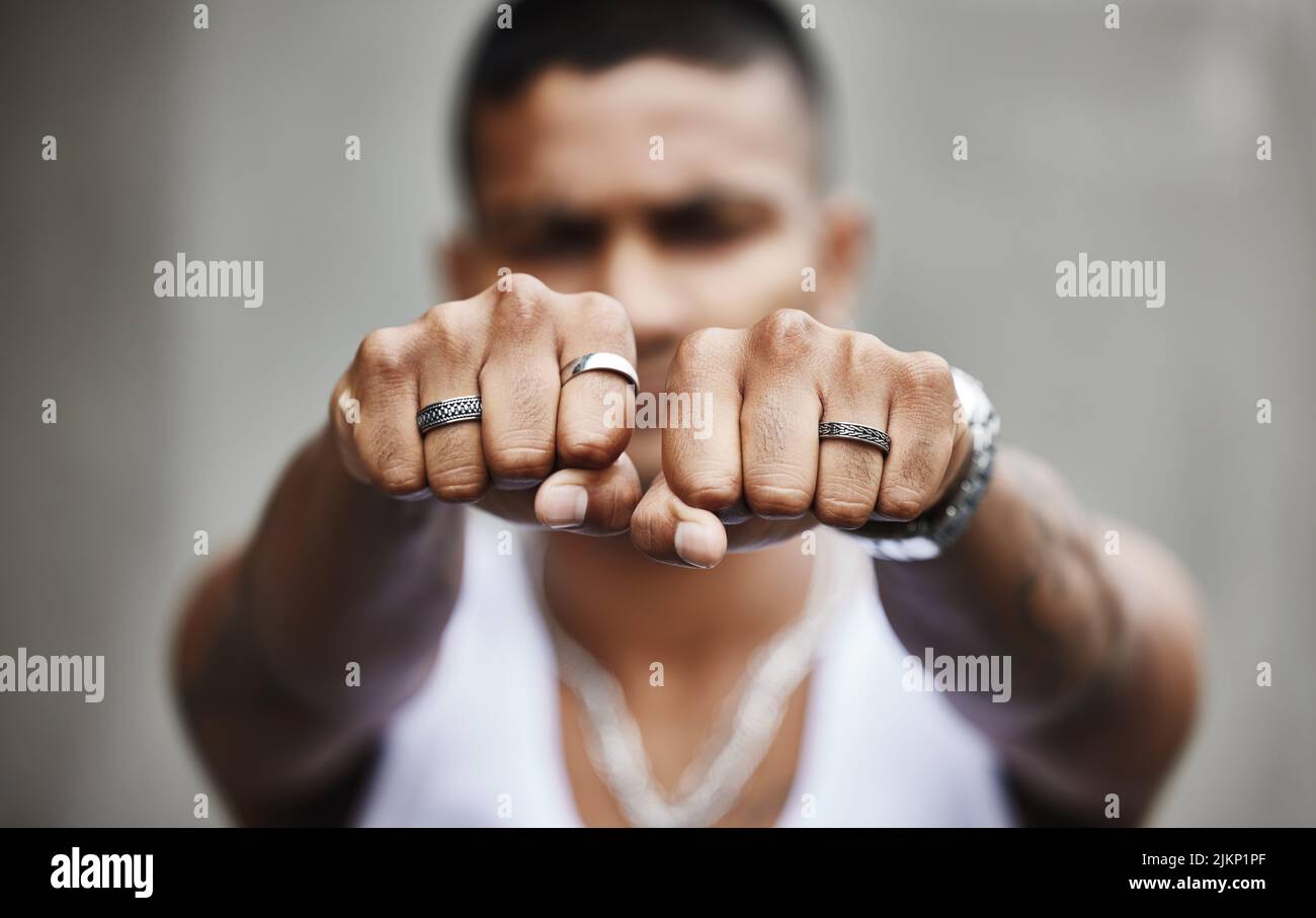 Its a rite of passage. Closeup shot of a male gangsters hands showing ...