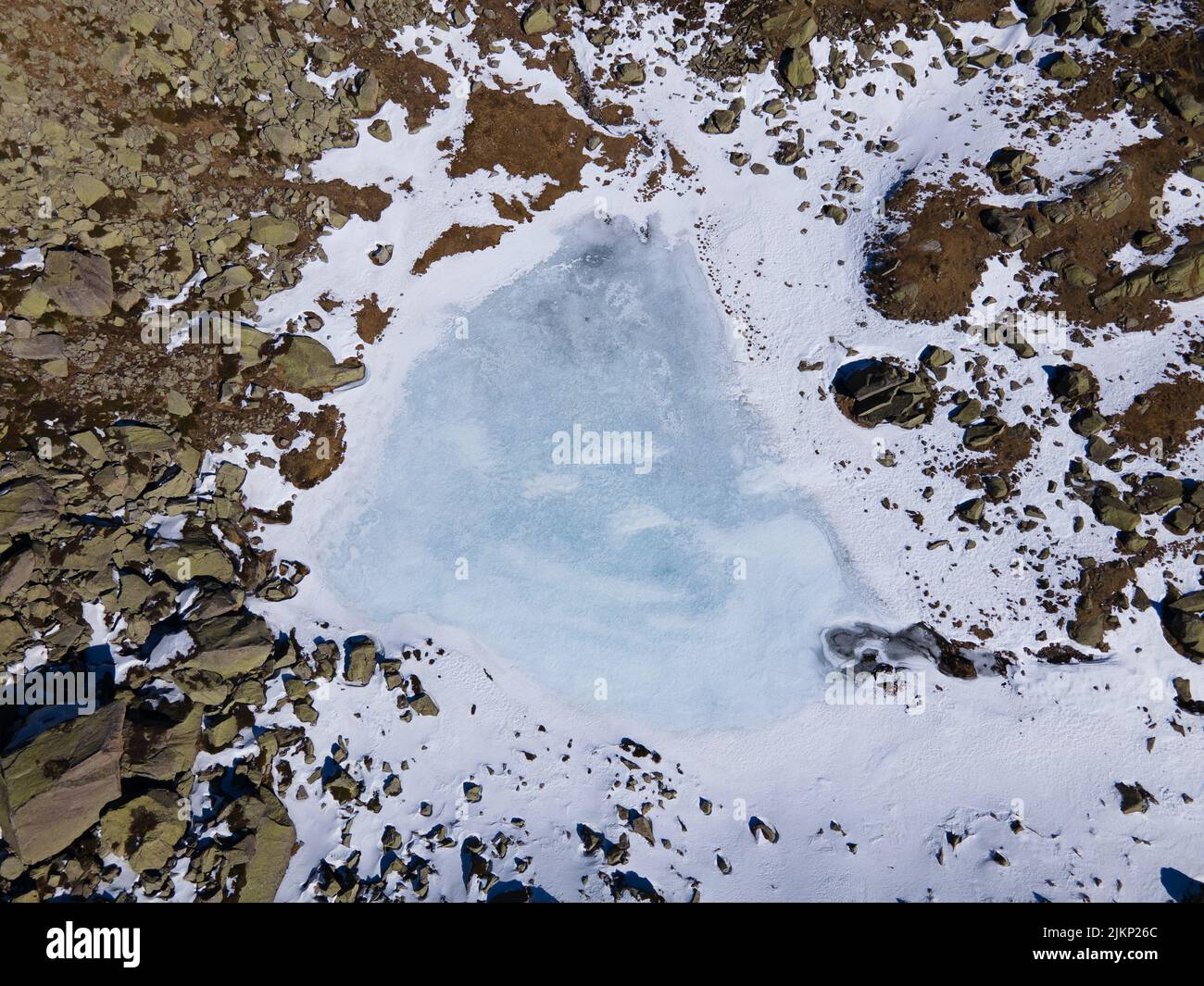 A top view shot of a frozen pond in a mountain Stock Photo - Alamy