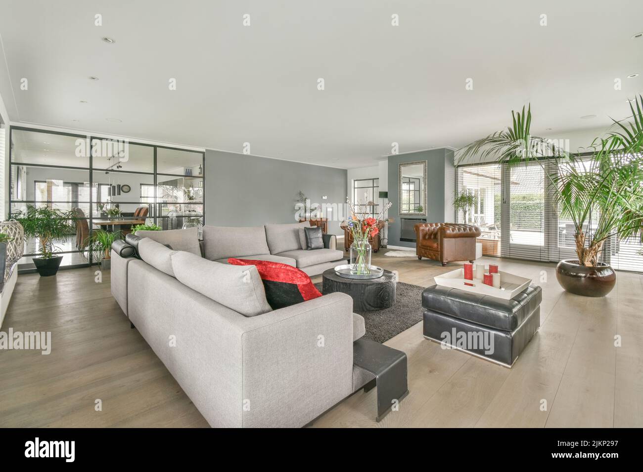 Square table placed on mat near couch and TV in stylish living room of ...