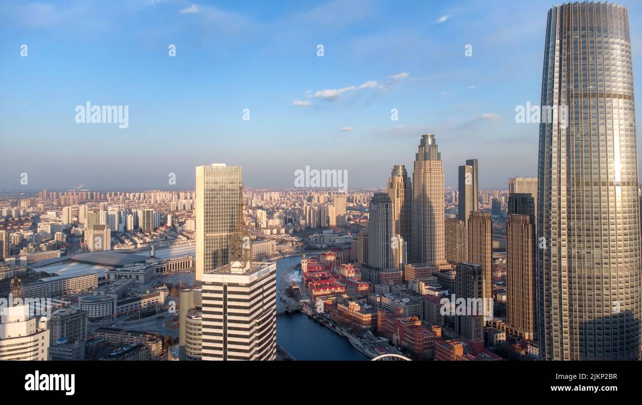A cityscape of Tianjin, China with skyscrapers and a river under the ...