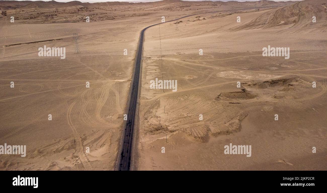 An aerial shot of a road passing through a desert in the sunlight Stock ...