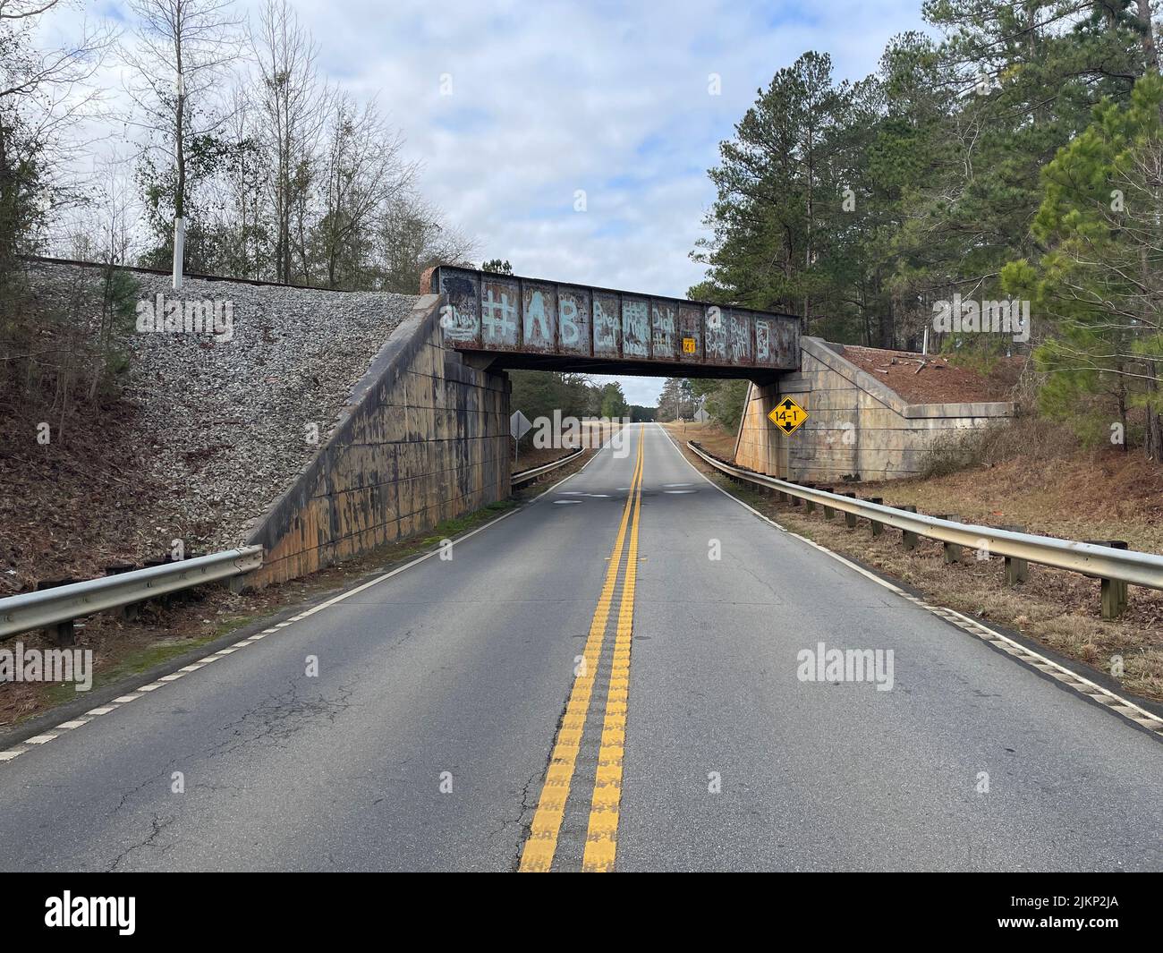 A low train bridge in the country and trees Stock Photo - Alamy