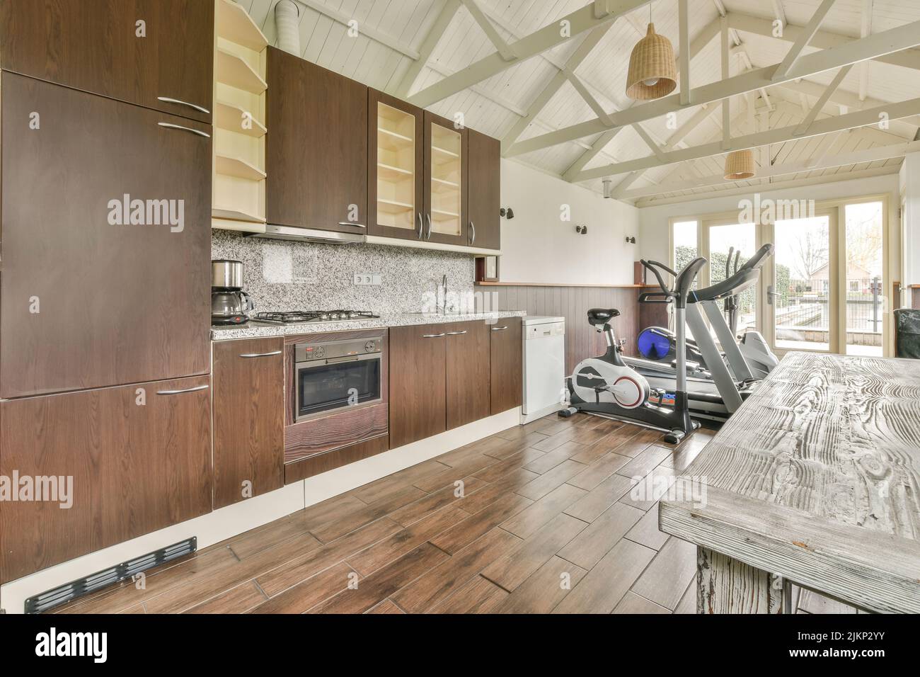 Interior of light kitchen with modern cupboards and appliances located ...