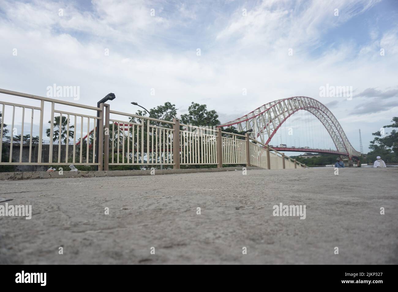 The Kutai Kartanegara Bridge under a cloudy sky. One of the largest ...