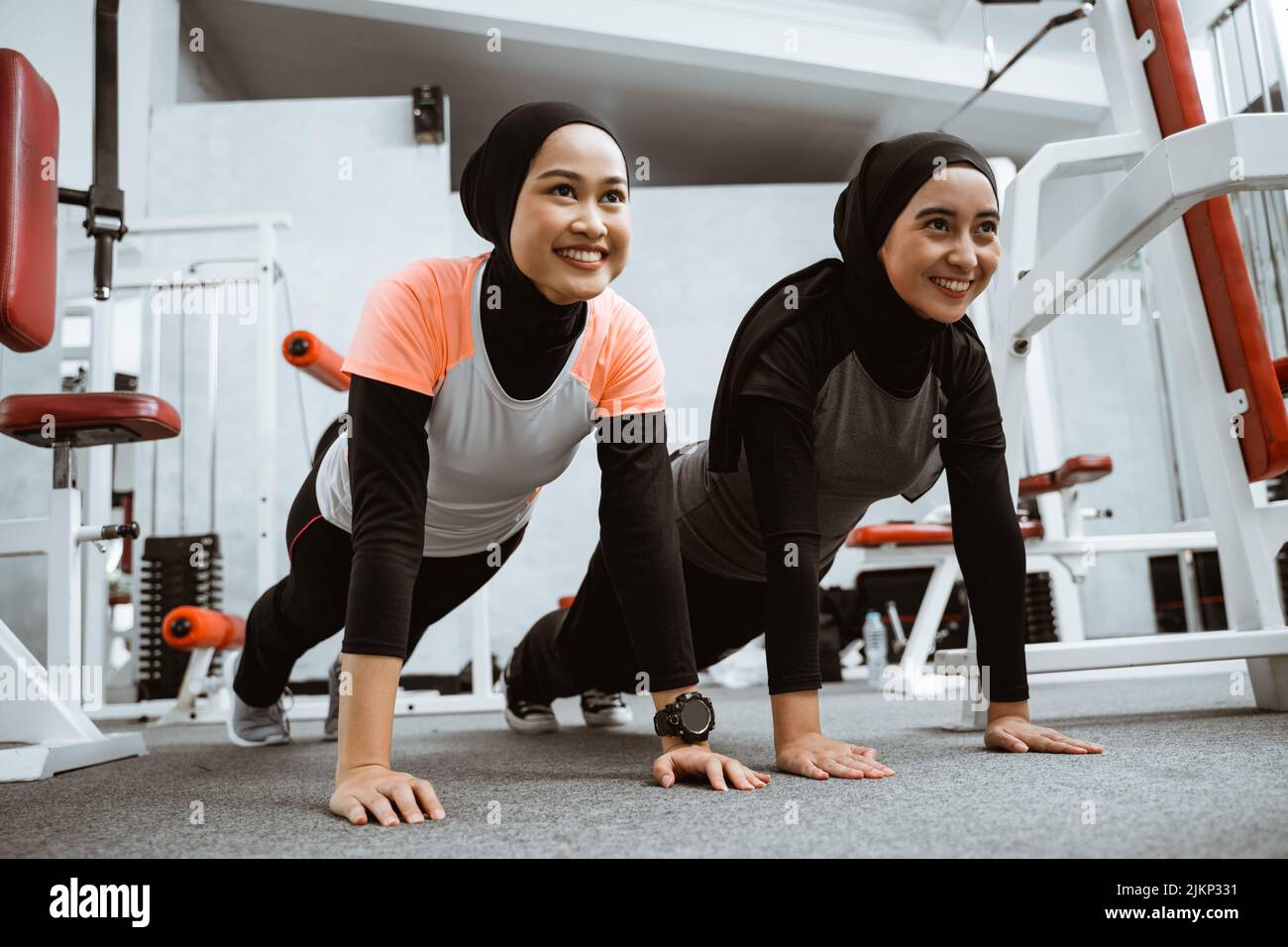 asian muslim woman doing plank push up with partner Stock Photo - Alamy