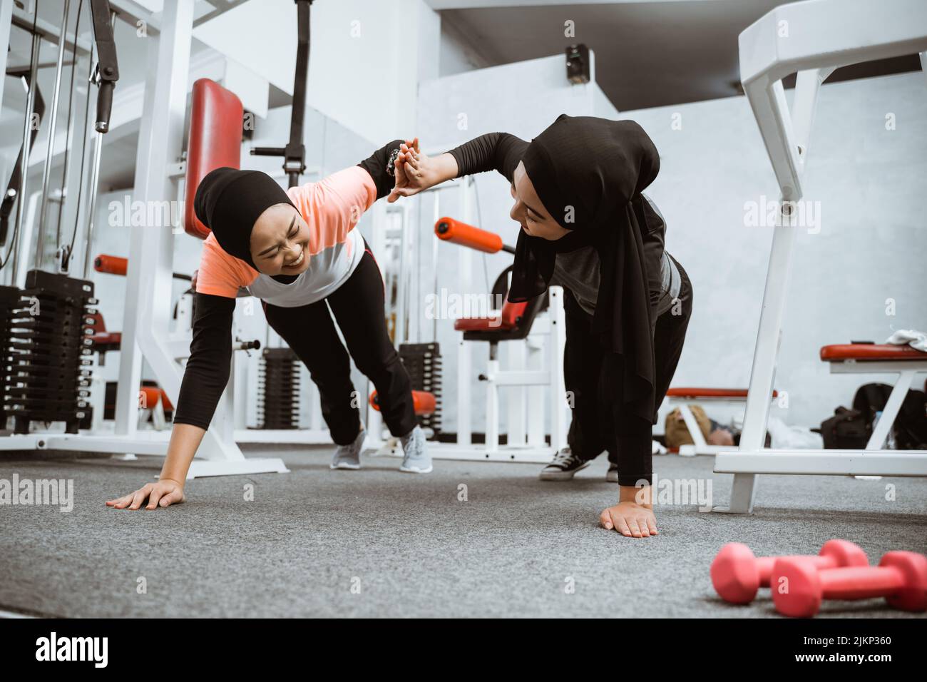 muslim woman with hijab push up and high five workout together Stock ...