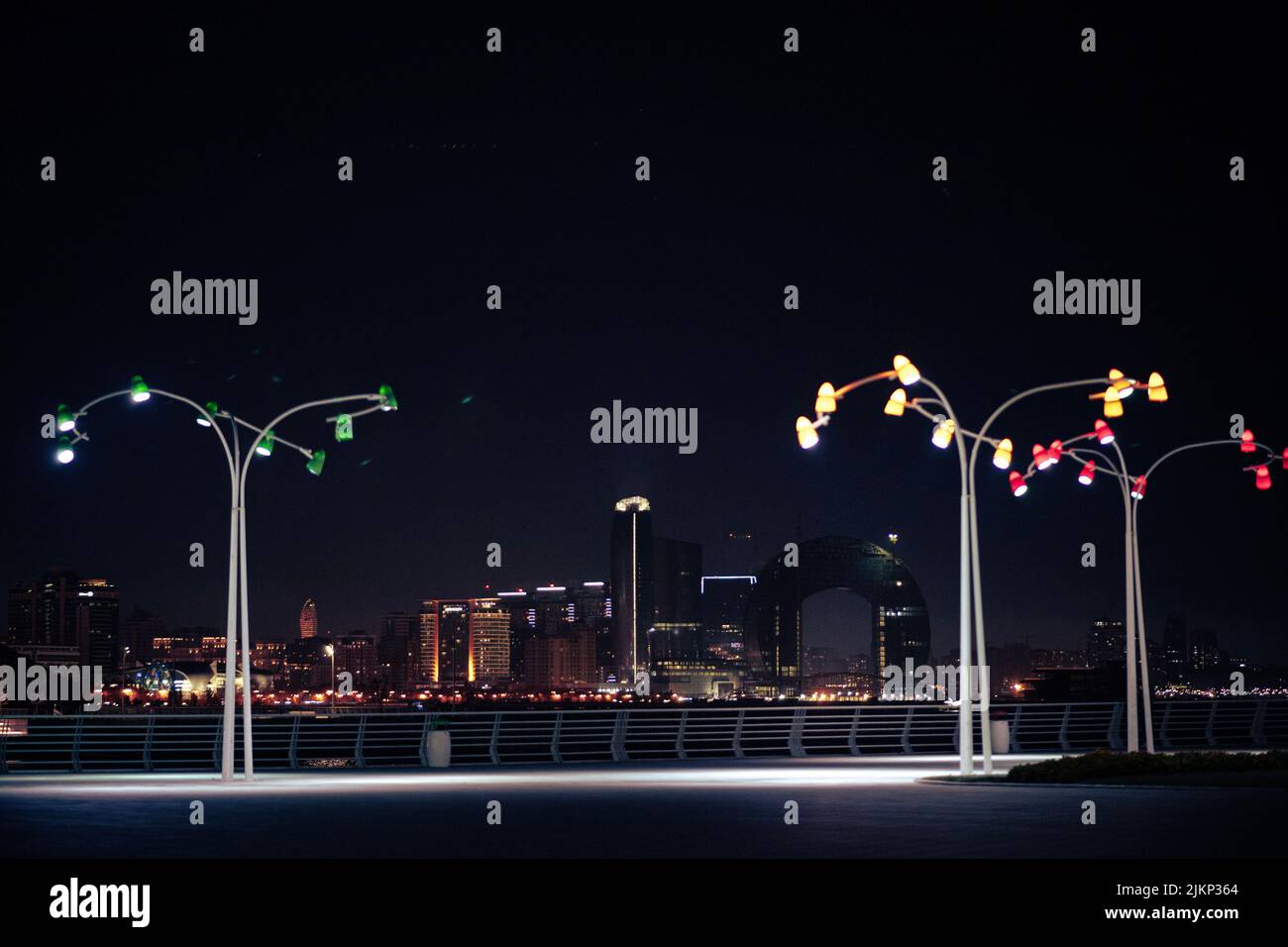 A Beautiful shot of lighting poles on a concrete bridge, buildings ...