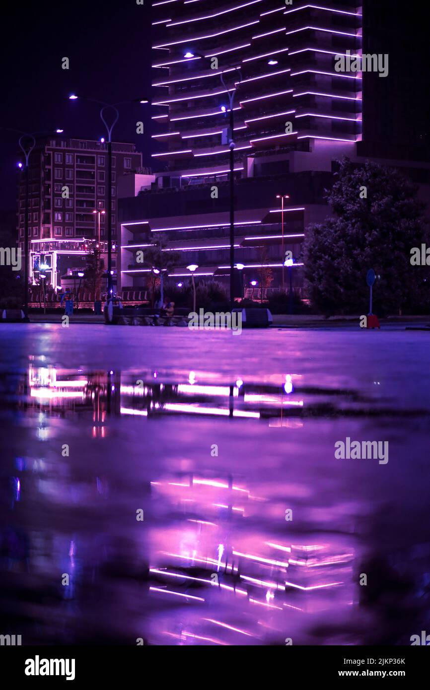 A beautiful shot of puddles on the street reflecting the buildings ...