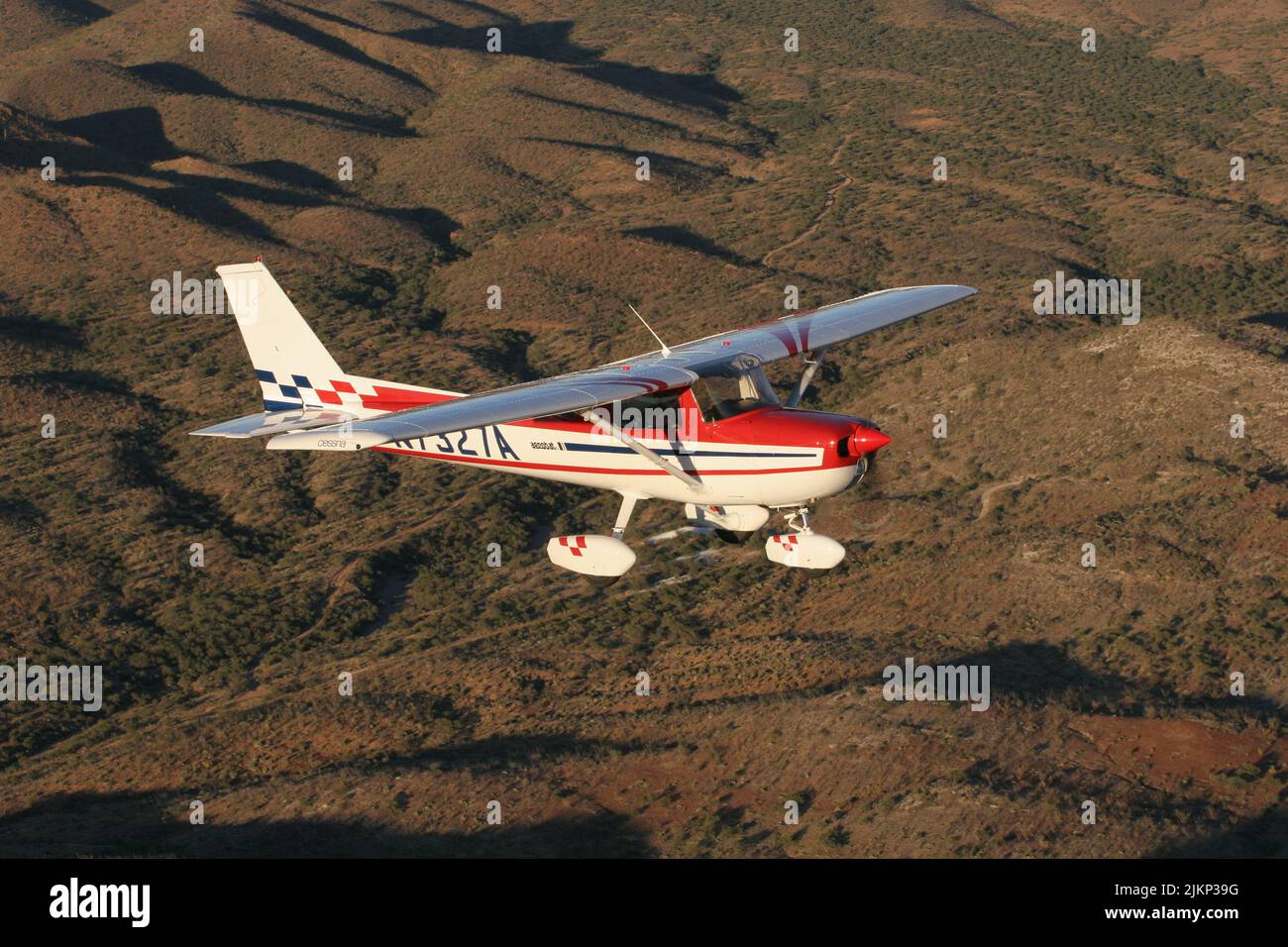 The Cessna 150 Aerobat A150M flying formation desert mountains Stock ...