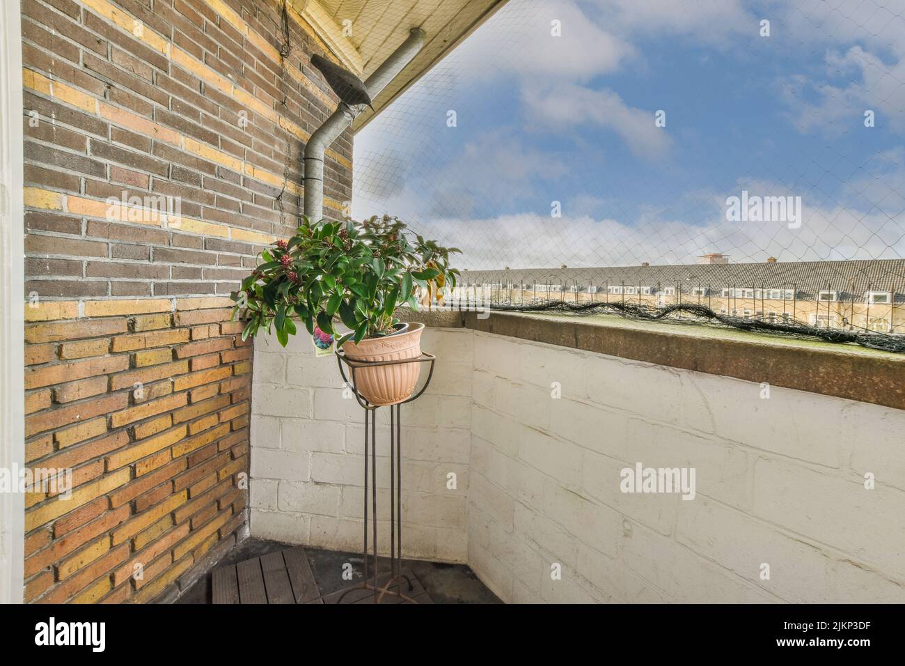 Front view of old brick buildings and from small balcony with railings ...