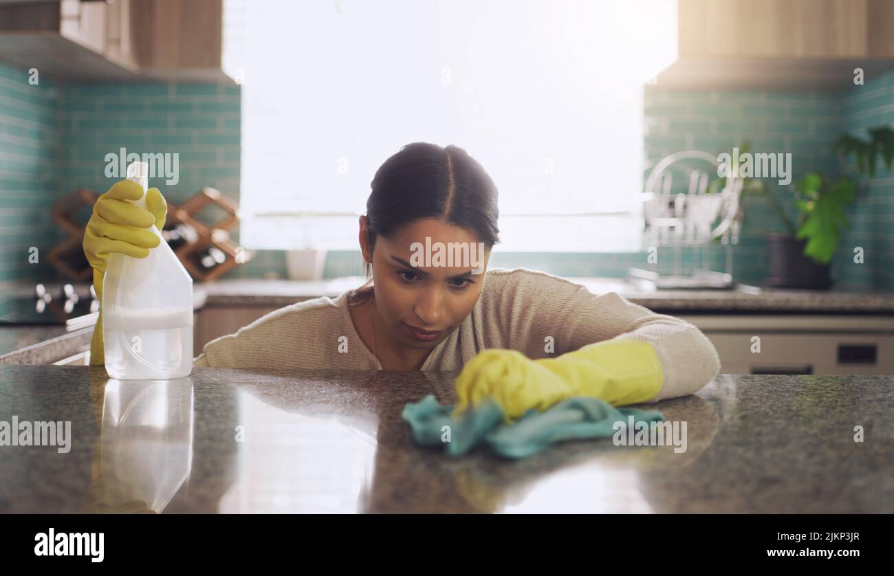Its a great day to get the house spotless. a young woman scrubbing down ...