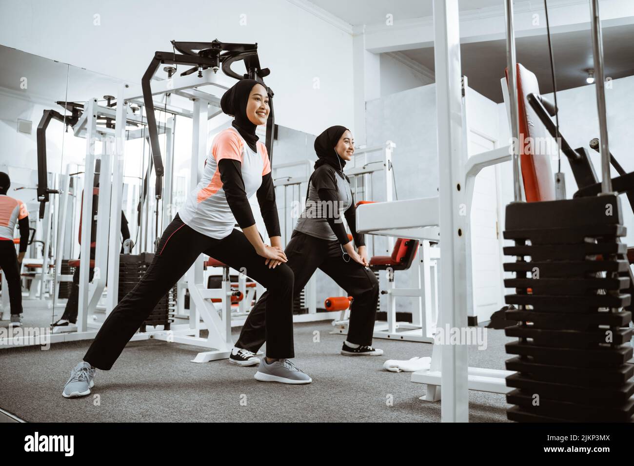 beautiful muslim woman stretching and exercising at the gym Stock Photo ...