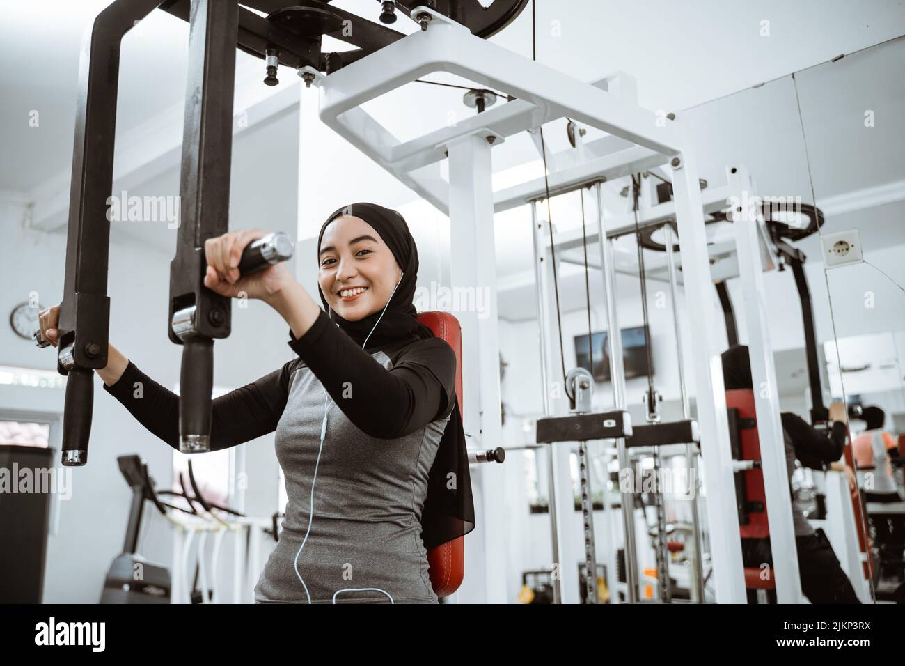 woman using chest press machine during fitness at the gym Stock Photo ...