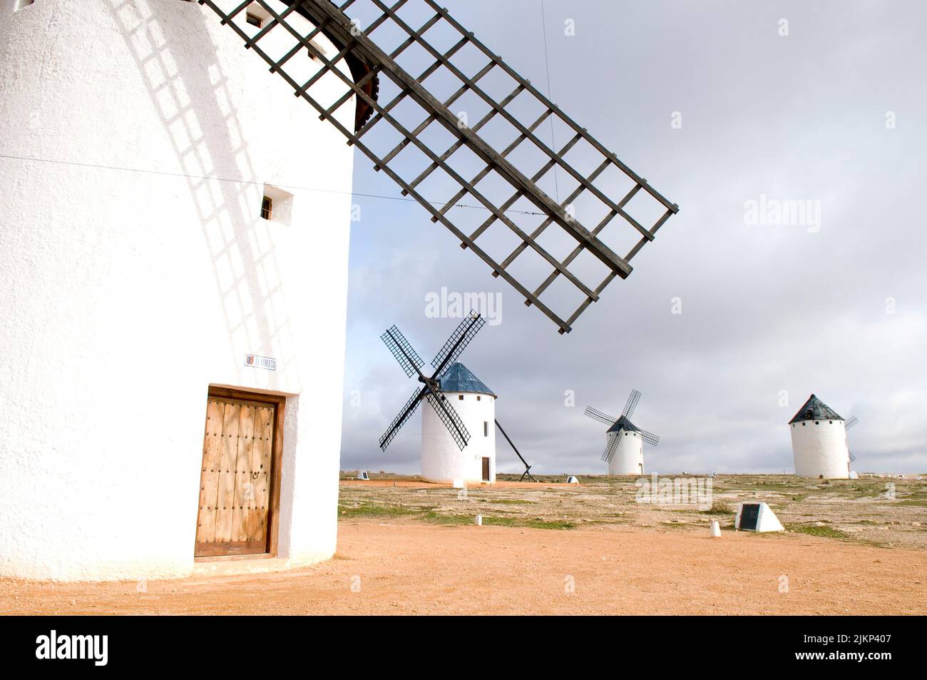 A close up of a giant spanish windmill and other windmills in the ...
