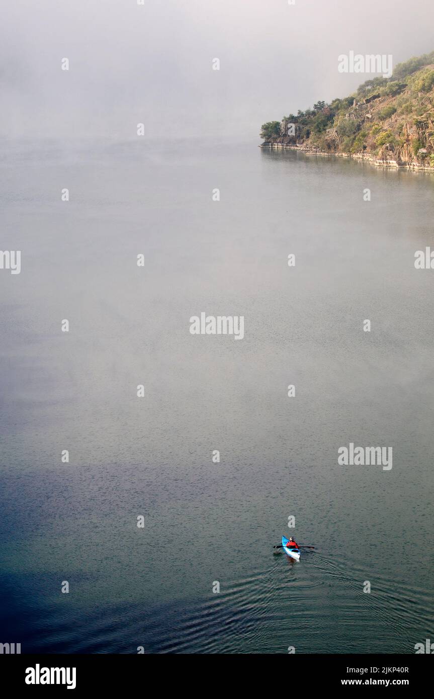 An aerial view of A kayaking trip on the Tagus River under the rain in ...