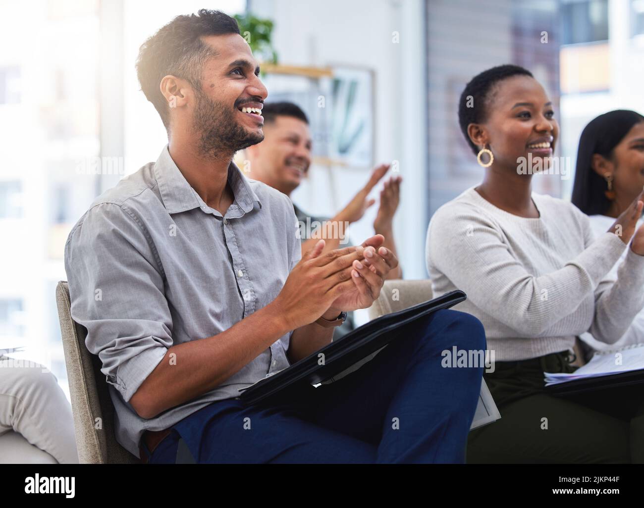 Best seminar Ive been to. a group of people clapping and smiling during ...