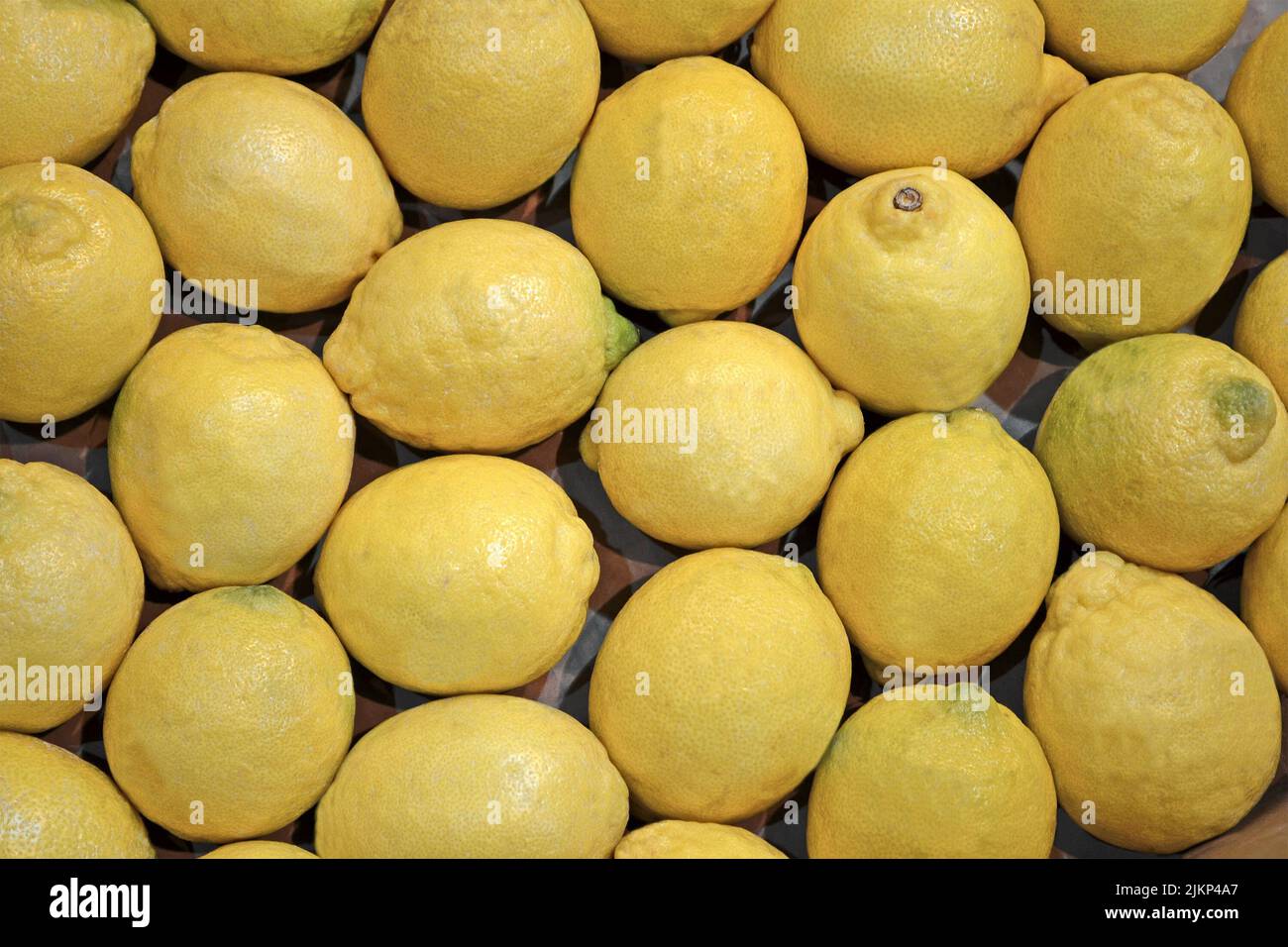 fresh yellow lemon heap in container, exotic food diversity Stock Photo ...
