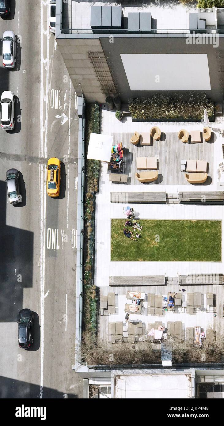 An aerial shot of a street and a building roof with plants on it Stock ...