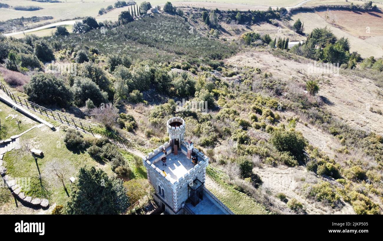 An aerial top view of a tower with people on open-top under the ...