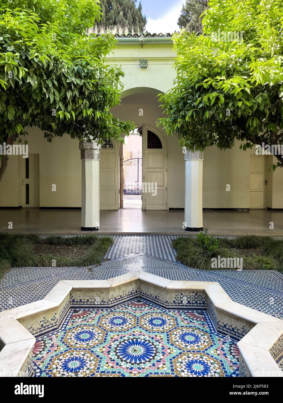 Empty mosaic courtyard with a small fountain in the middle Stock Photo ...