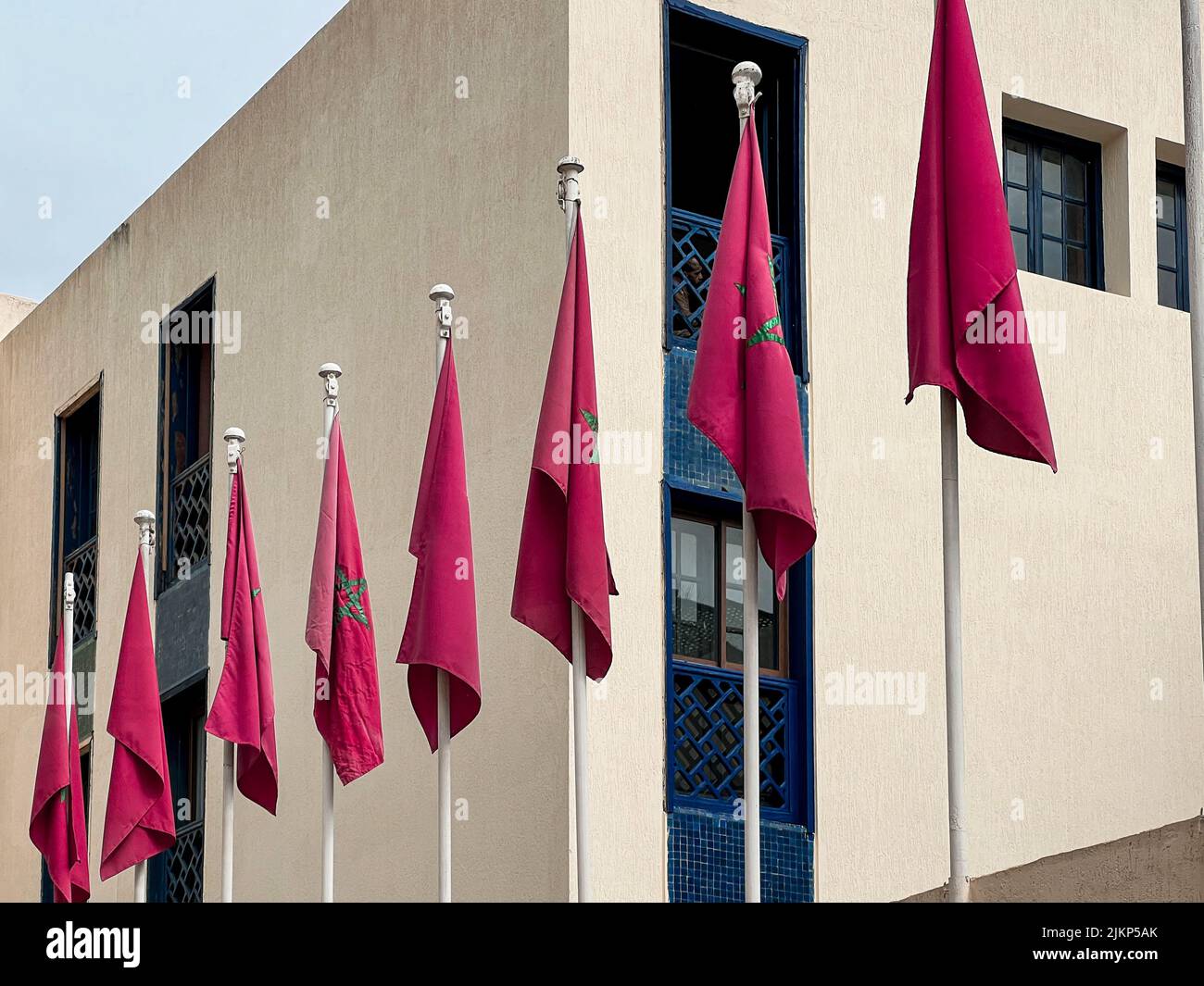 Row of Moroccan flags hanging on the wall of a hotel in the medina of ...