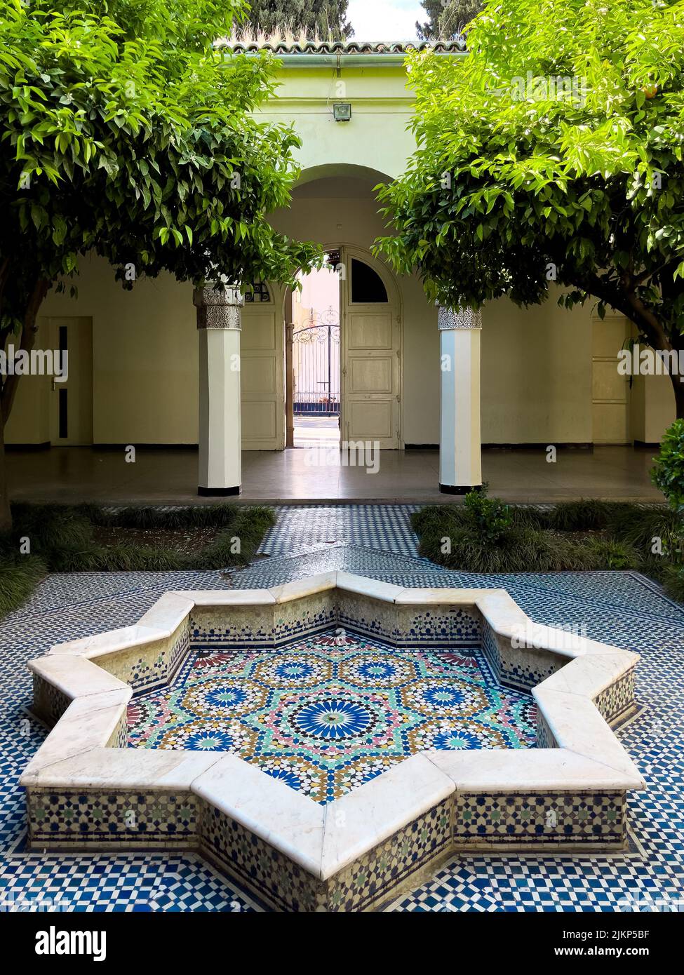 Empty mosaic courtyard with a small fountain in the middle Stock Photo ...