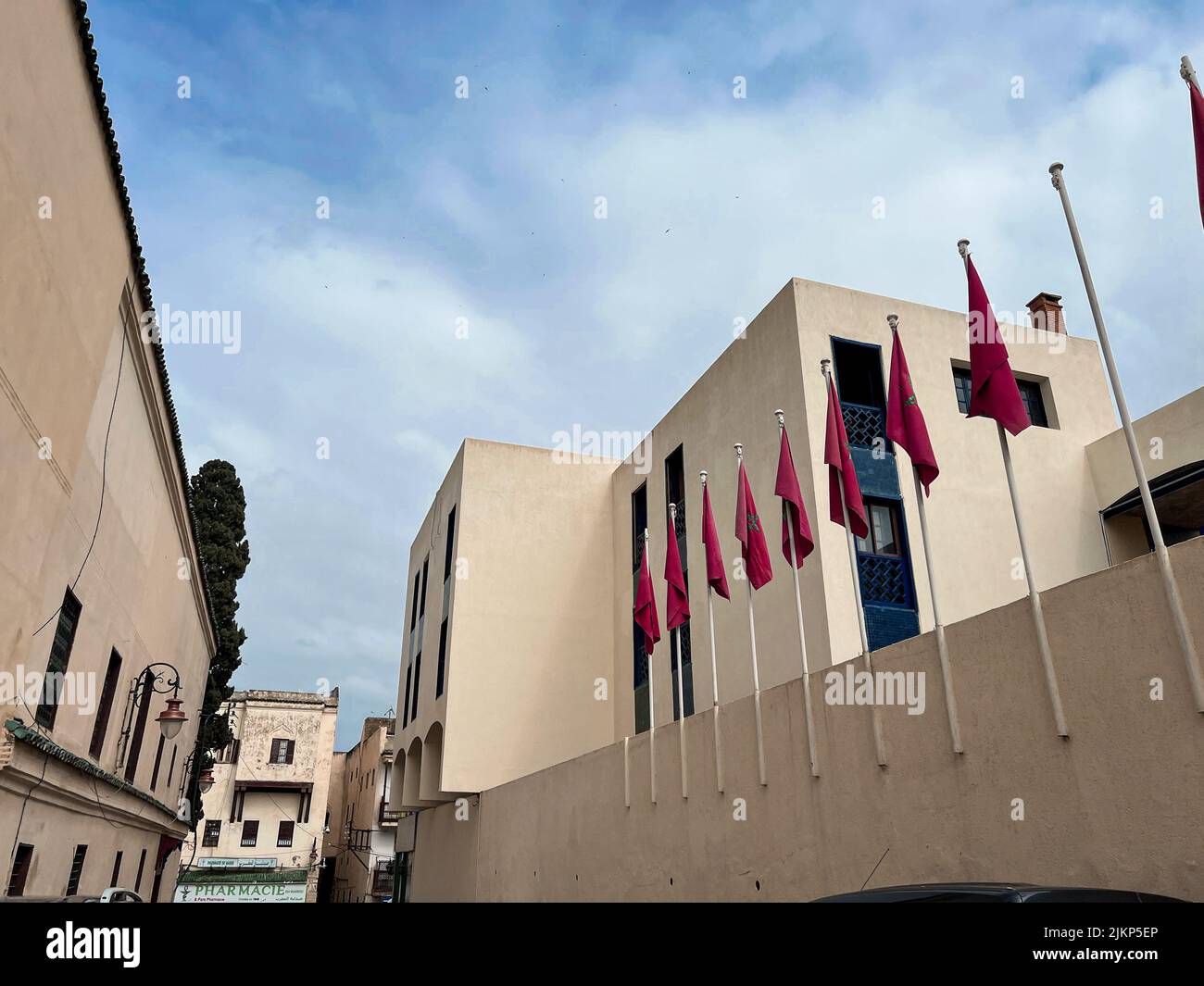Row of Moroccan flags hanging on the wall of a hotel in the medina of ...
