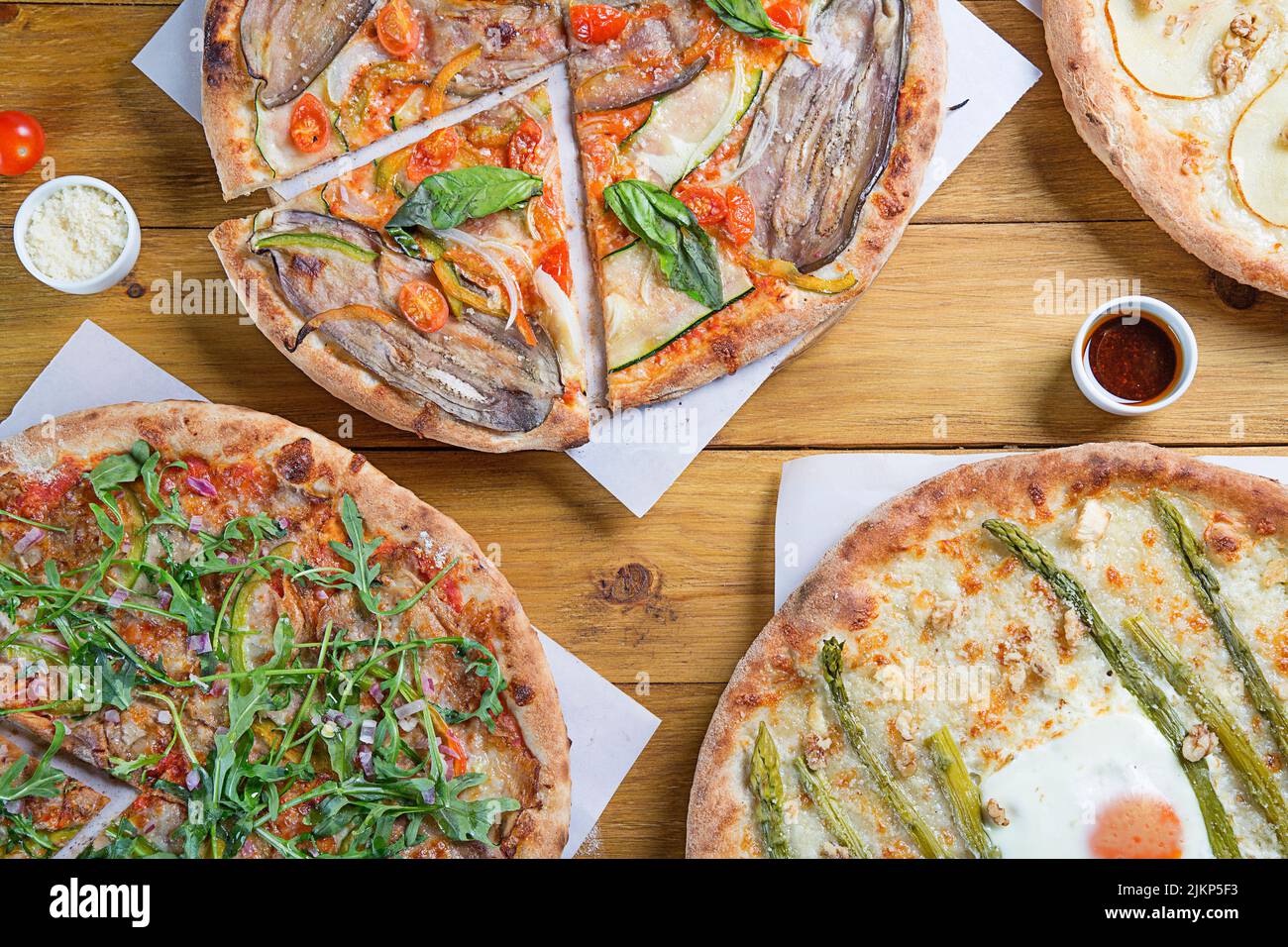 A top view of the selection of different pizzas on a wooden table Stock ...