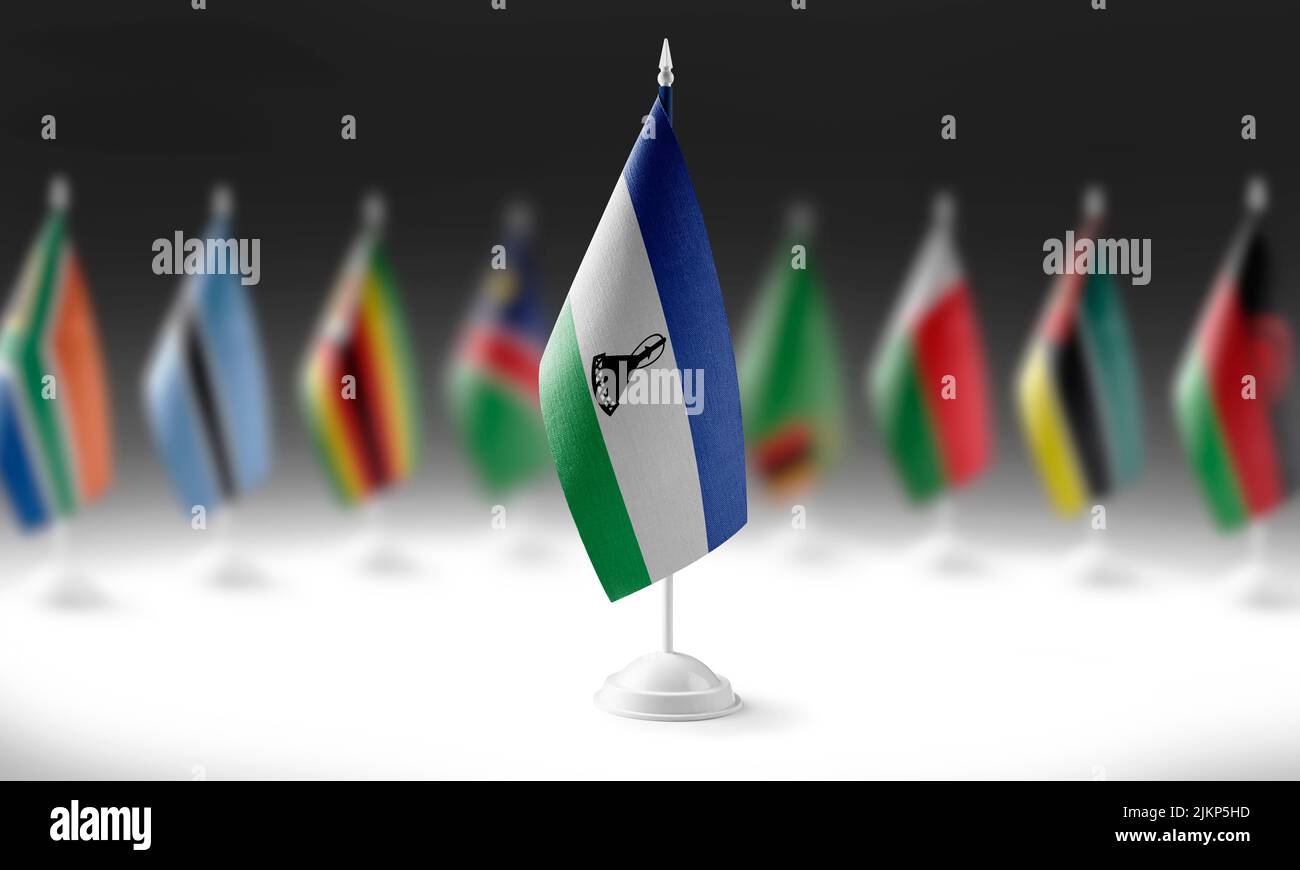 The national flag of the Lesotho on the background of flags of other ...
