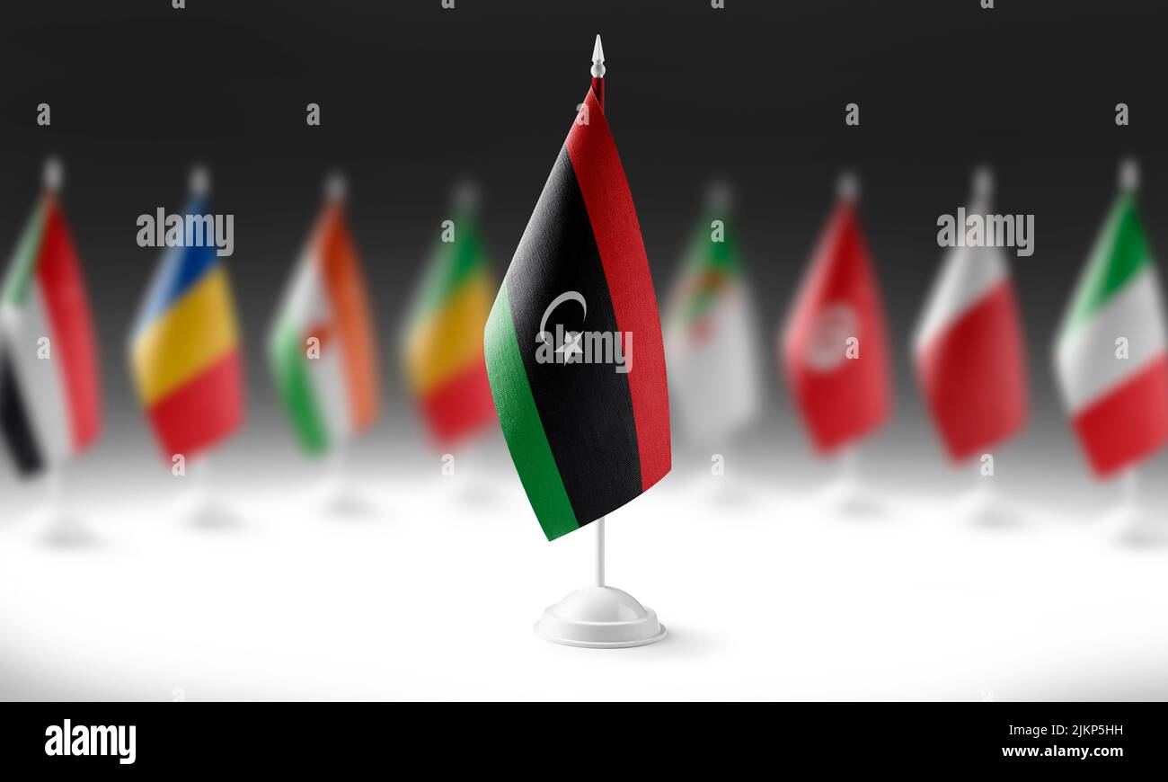 The national flag of the Libya on the background of flags of other ...