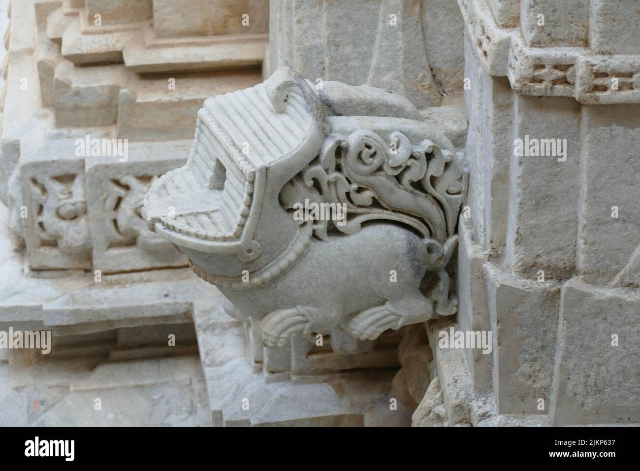 A closeup of an intricate sculpted animal figure in the Ranakpur Jain ...