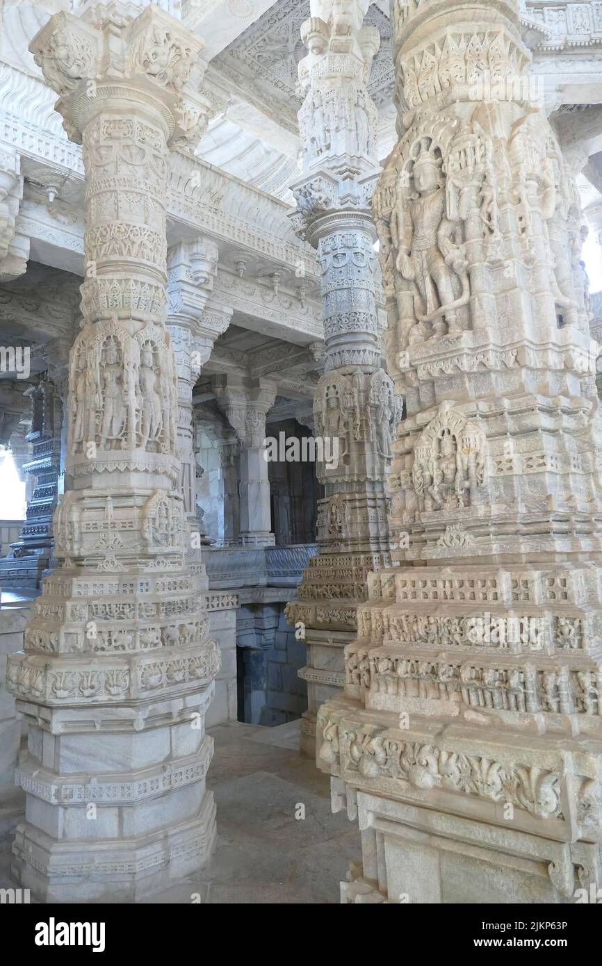 A vertical shot of intricate sculpted columns in the Ranakpur Jain ...