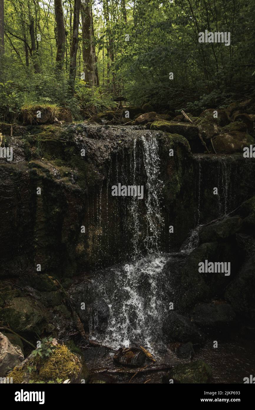 A beautiful shot of a waterfall covered with moss Stock Photo - Alamy