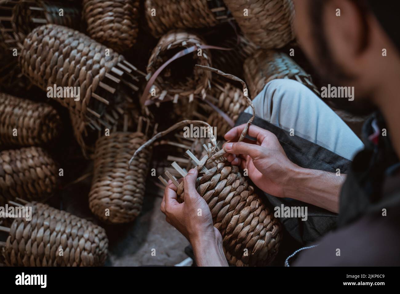 top view of bearded craftsman weaving crafts Stock Photo - Alamy