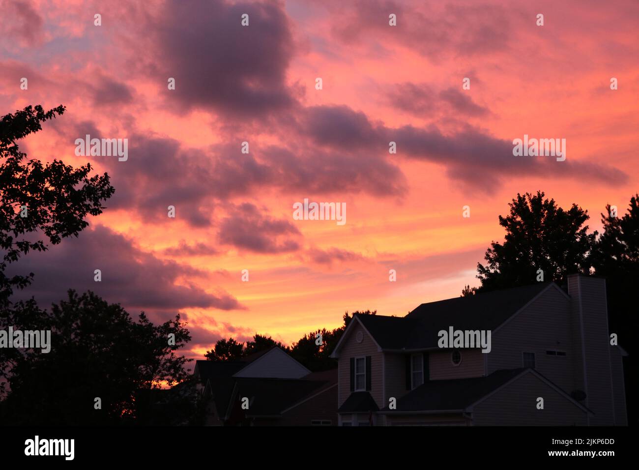 A scenic sunset over a neighborhood Stock Photo - Alamy