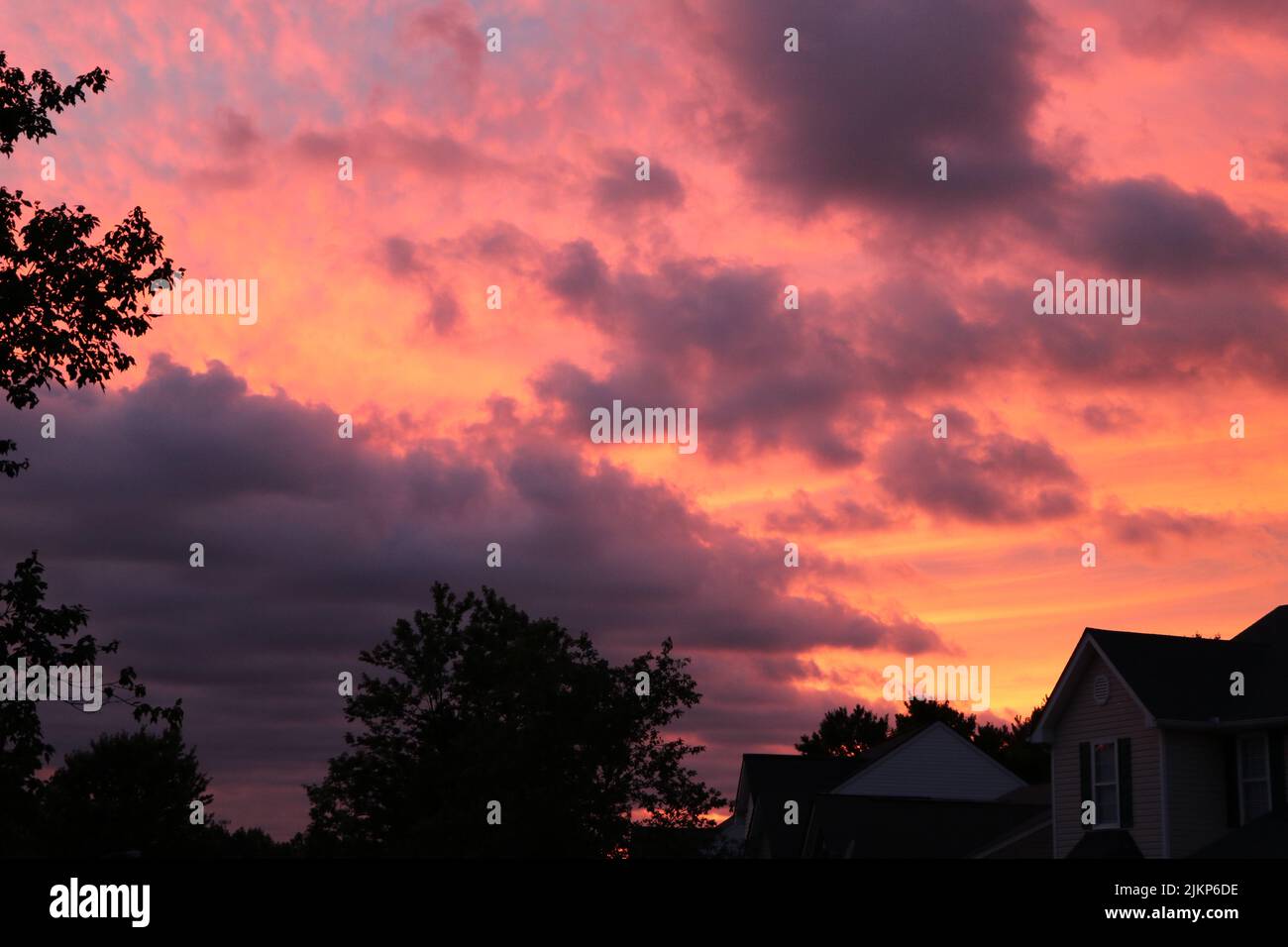 A scenic sunset over a neighborhood Stock Photo - Alamy