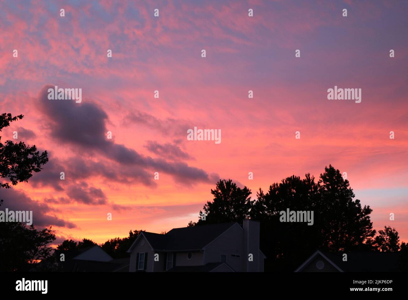 A scenic sunset over a neighborhood Stock Photo - Alamy