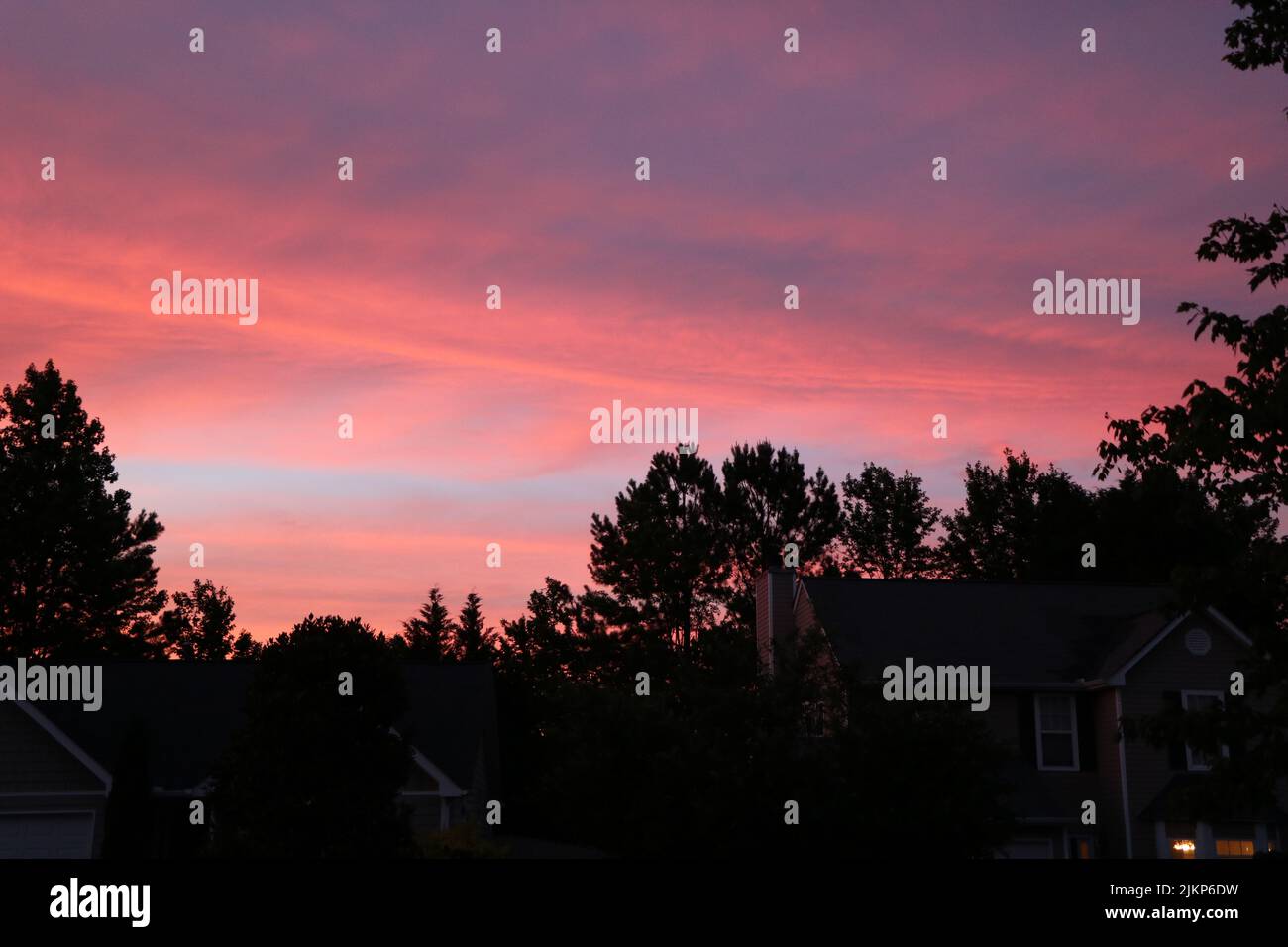 A scenic sunset over a neighborhood Stock Photo - Alamy