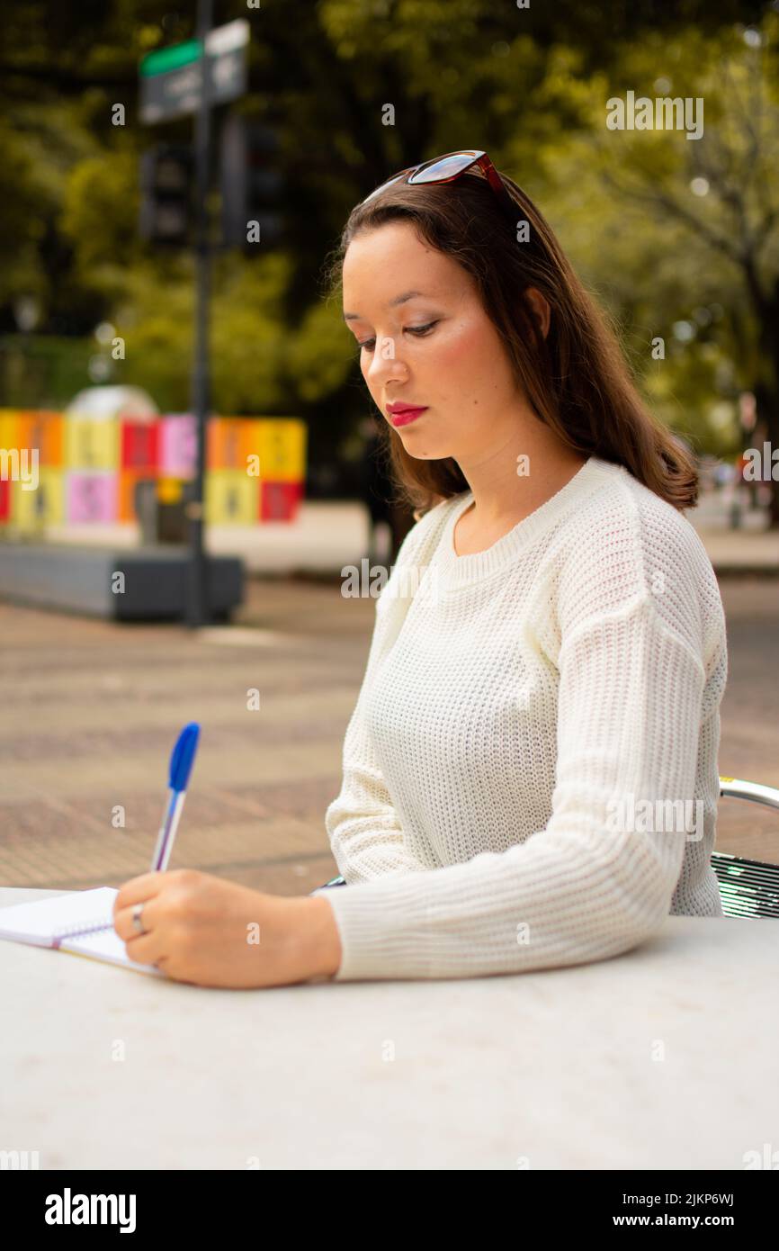 Hispanic girl writing on laptop desk hi-res stock photography and ...