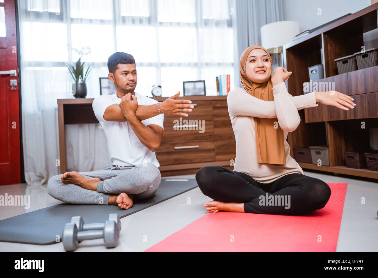 partner workout and stretching together at living room Stock Photo - Alamy